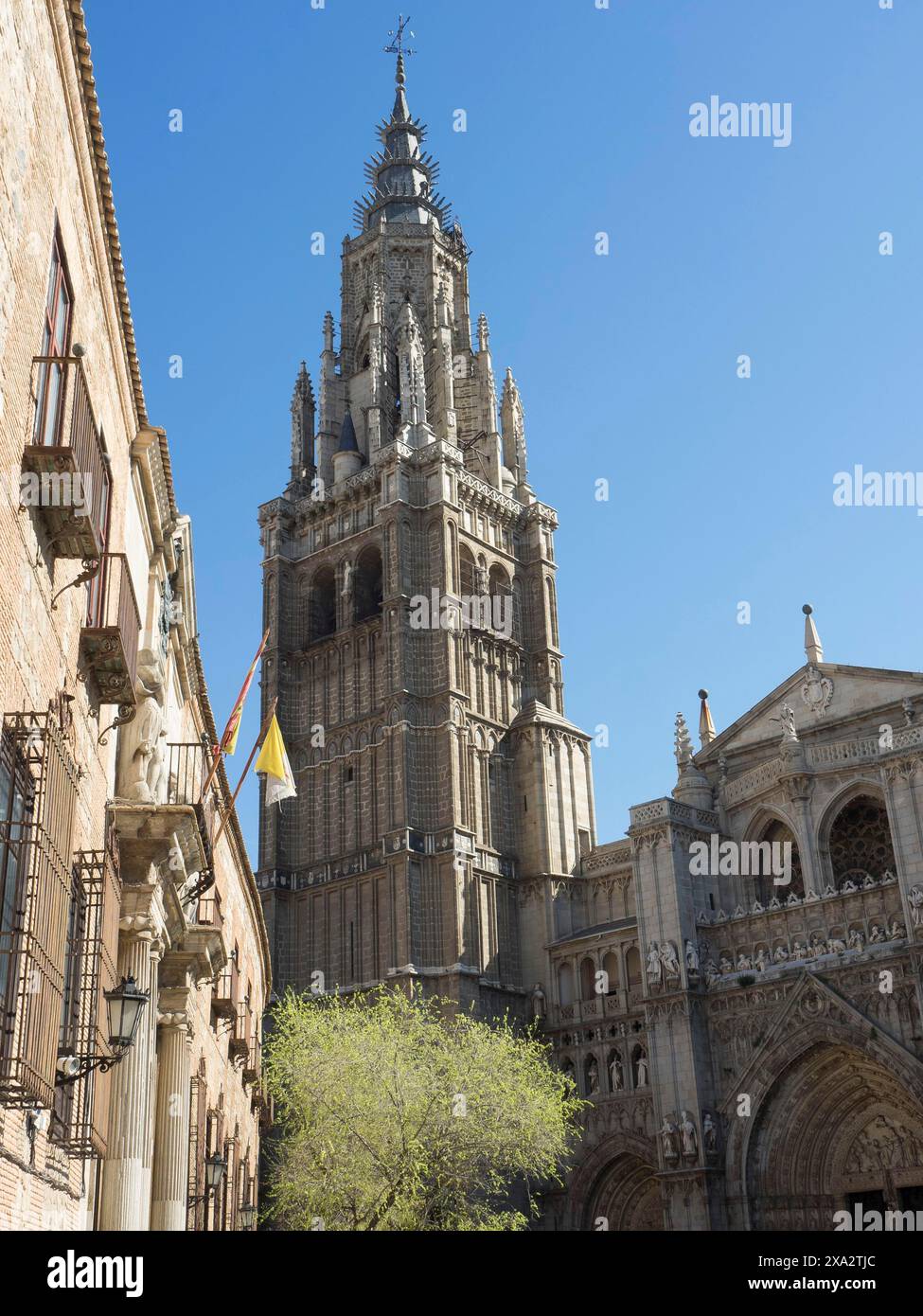 Gothic church tower rises against a clear blue sky, surrounded by ...