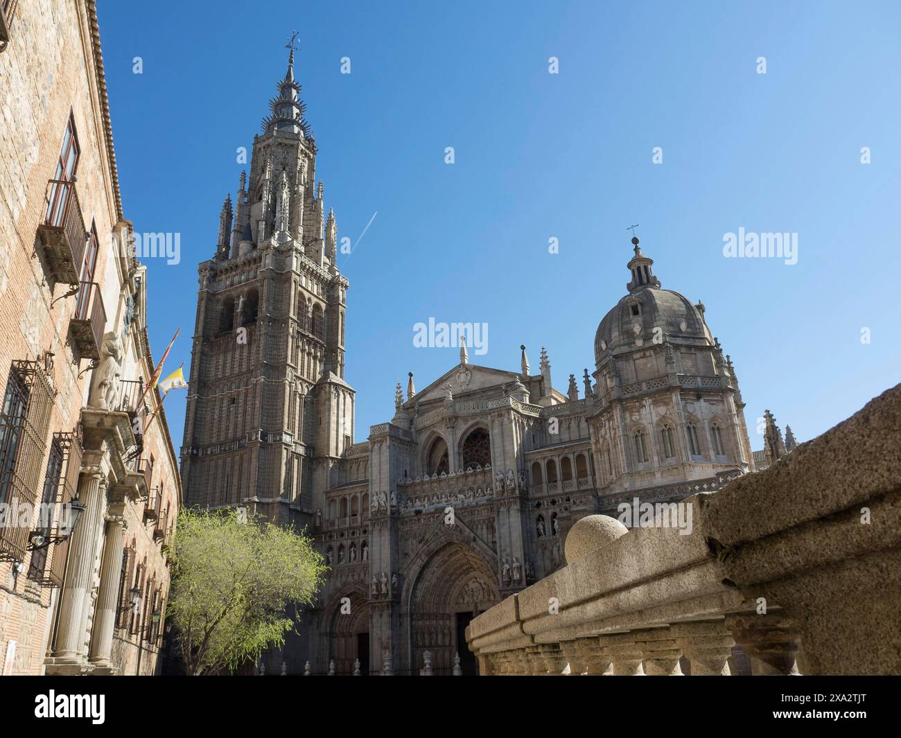 Historic cathedral with striking church tower, blue sky and stone wall ...