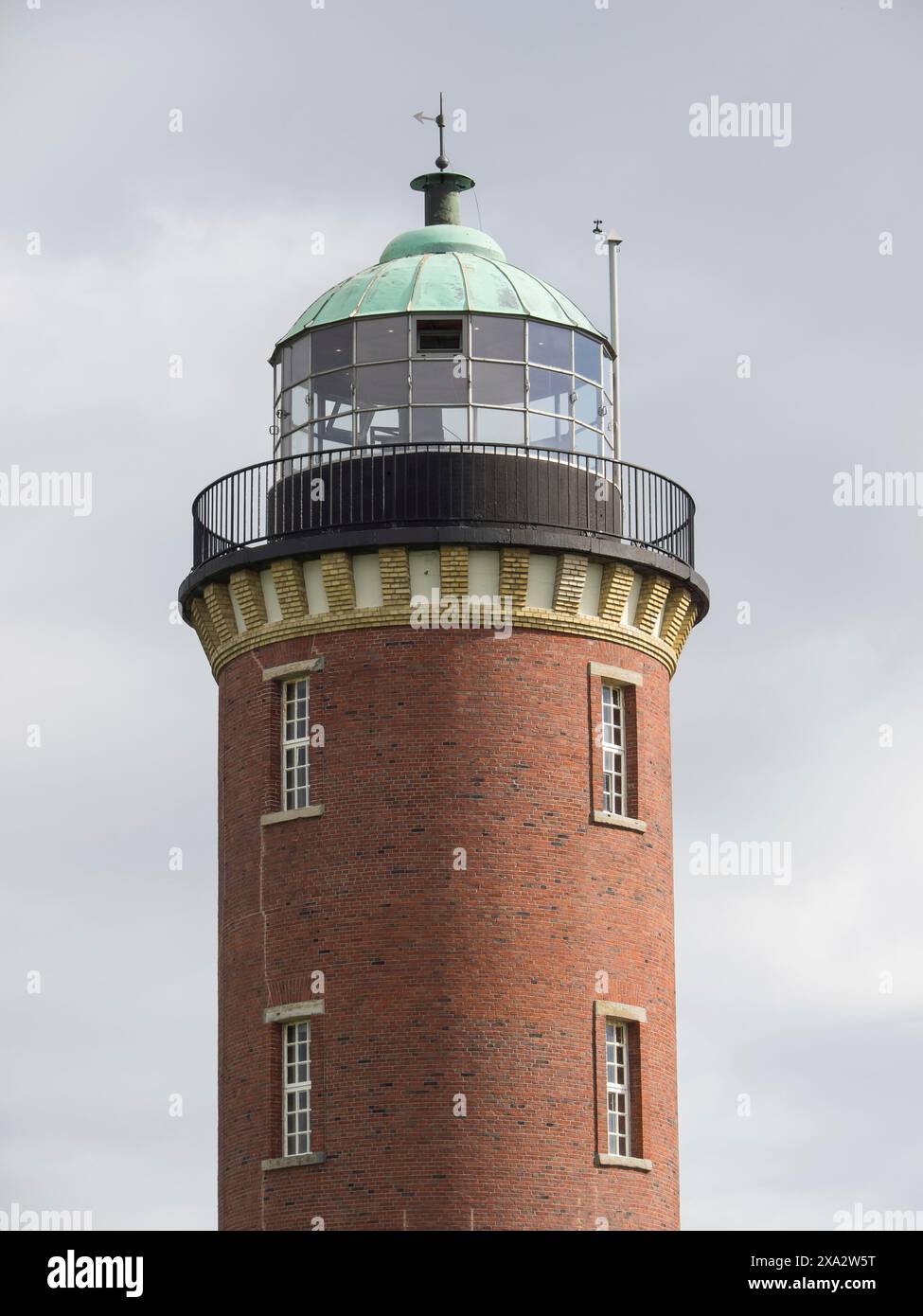 Brick lighthouse with green dome under a partly cloudy sky, Cuxhaven ...