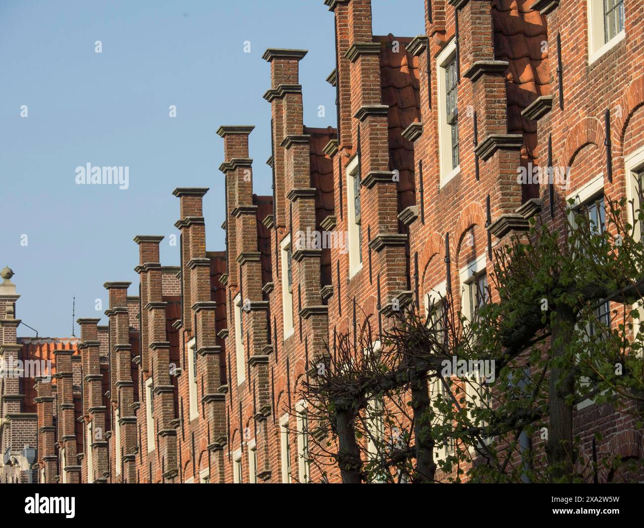 Detail of a historic brick building with distinctive gables and windows ...