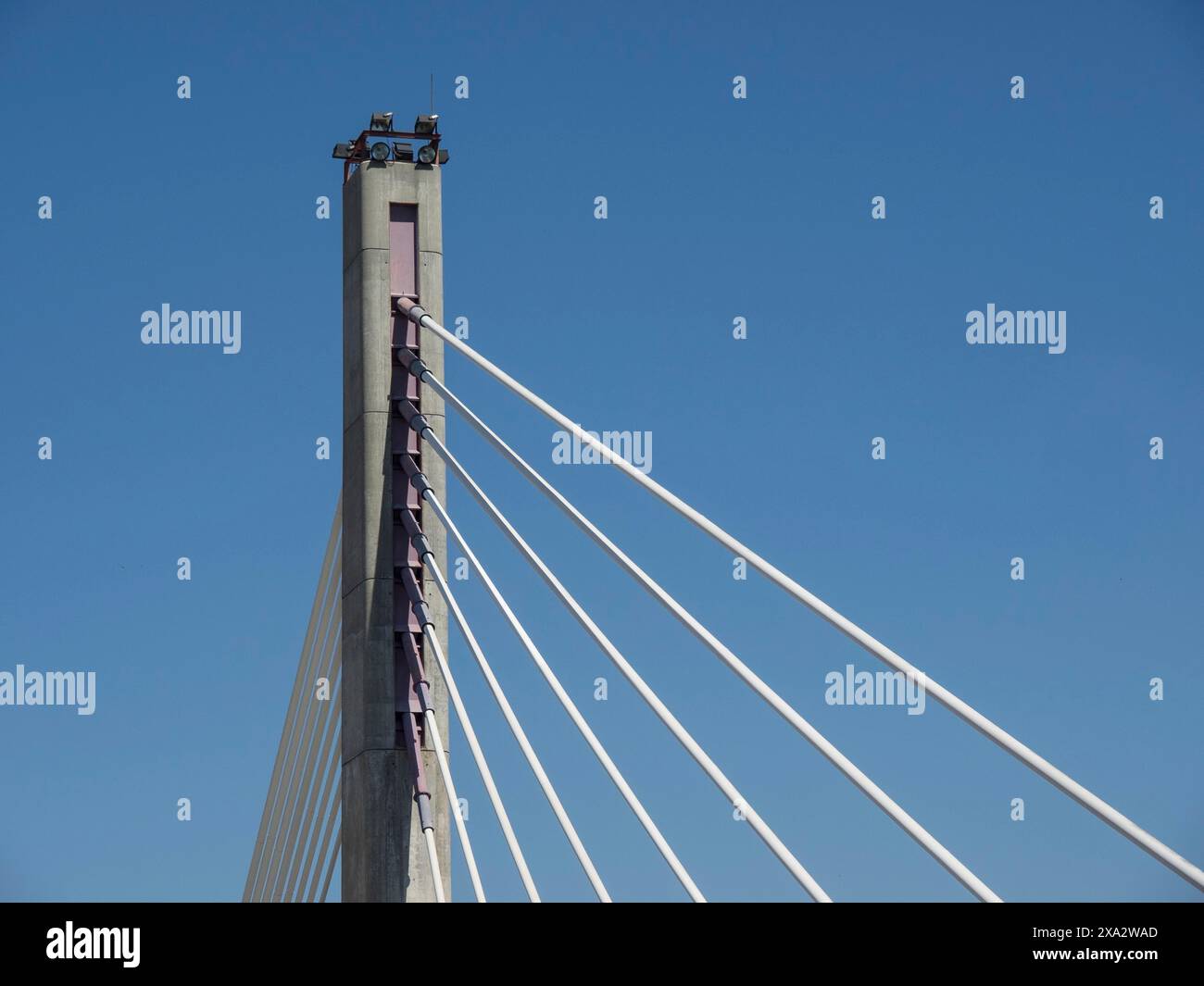 A modern bridge design with cables and a high structure under a blue ...