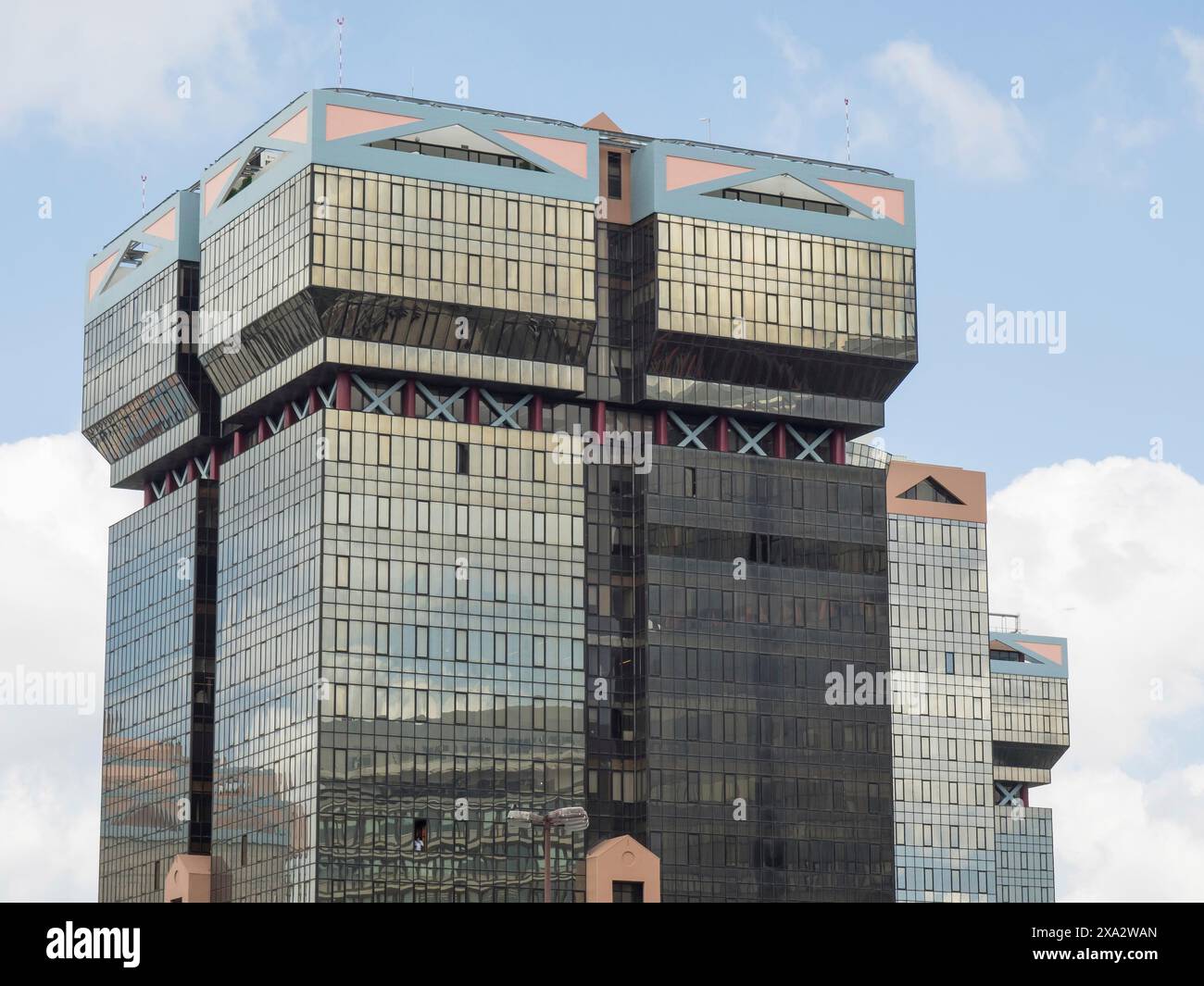 Glass tower block with striking postmodern architecture under a clear ...