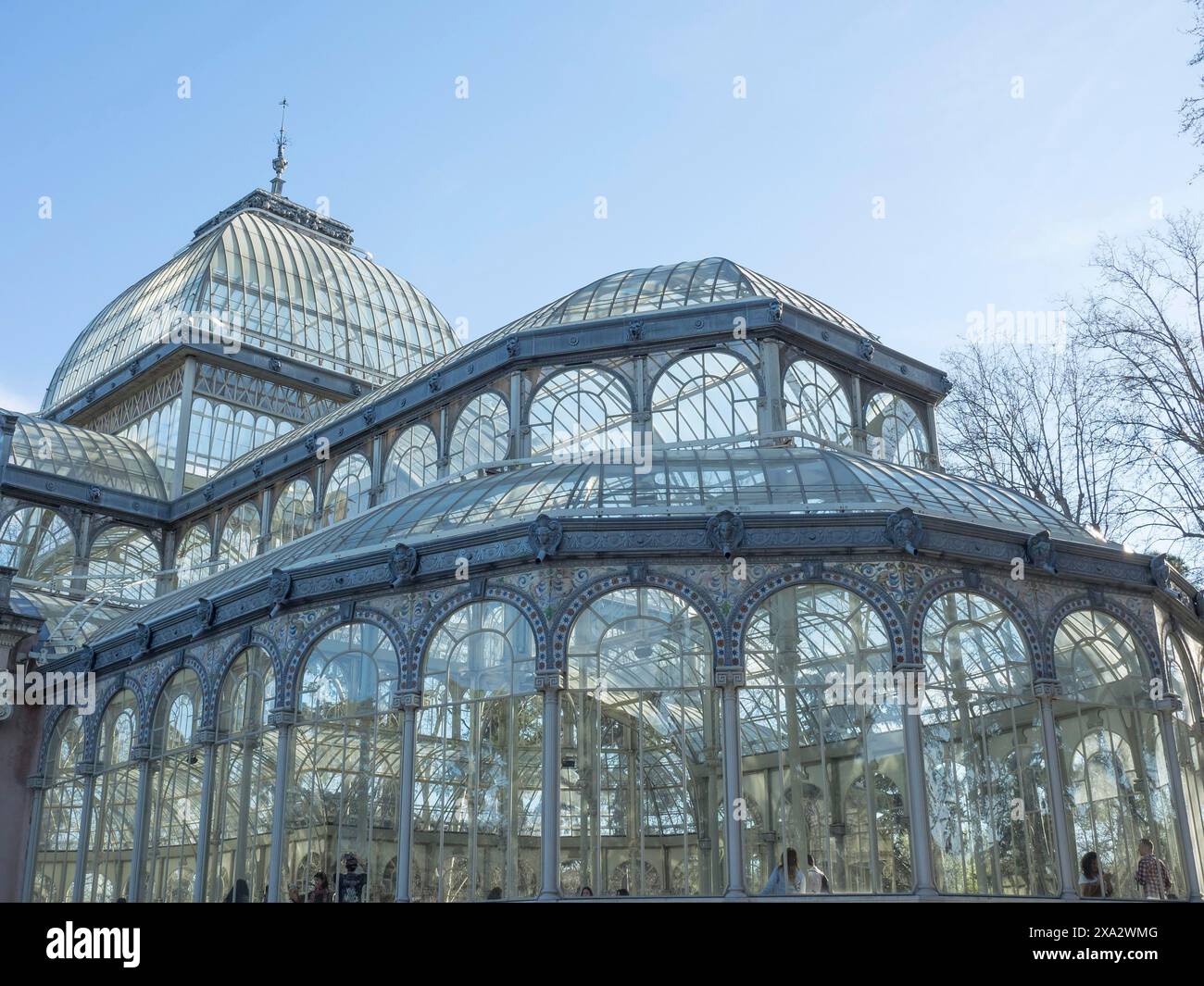 Large glass greenhouse with metallic frame that captures sunlight and ...