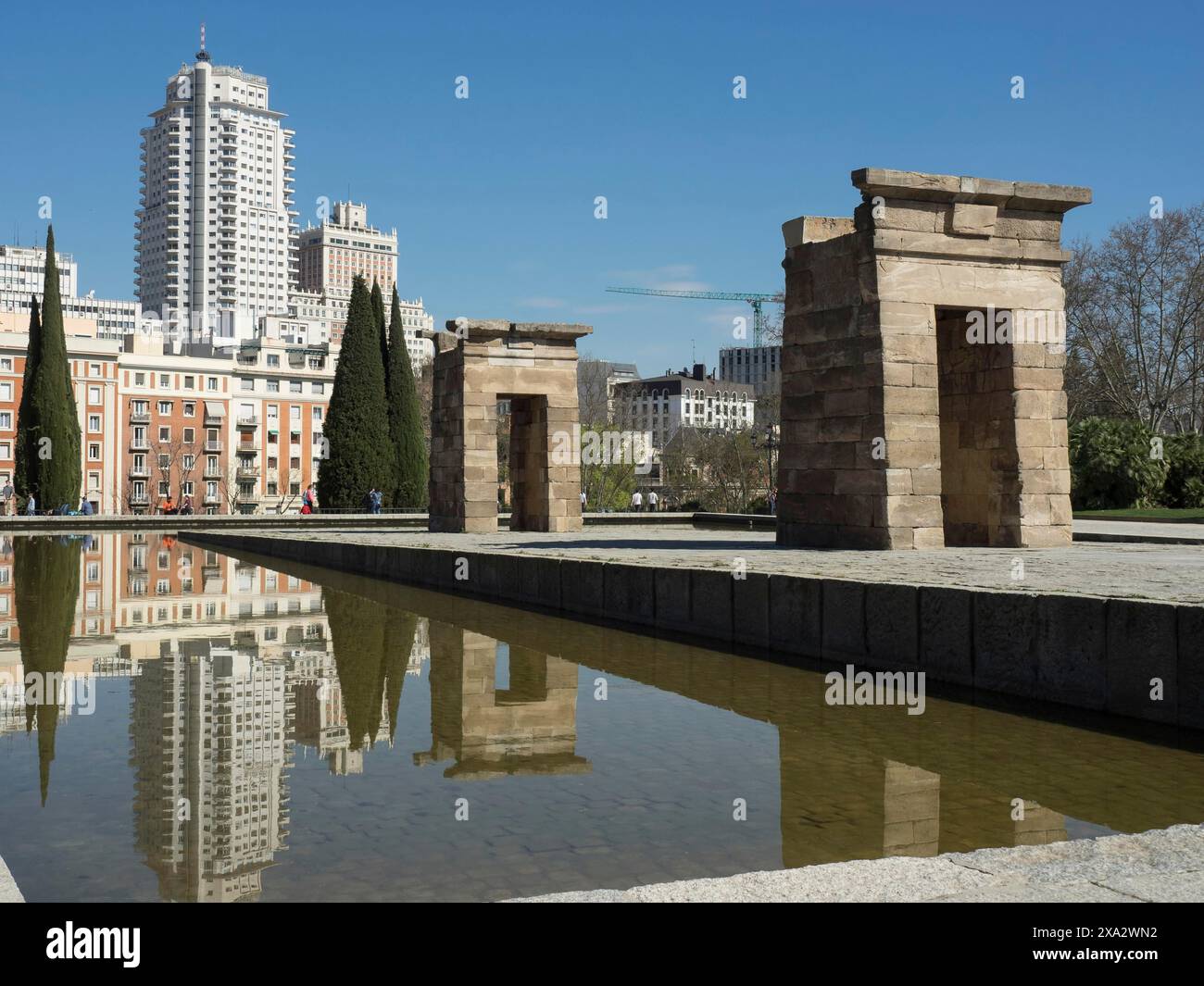 Two ancient temple pylons reflected in the water with modern ...