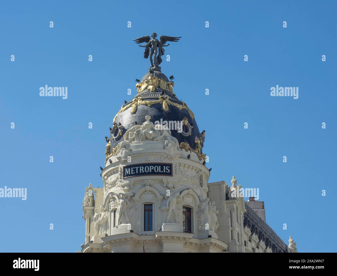 Building detail with magnificent dome and sculpture, all under a clear ...