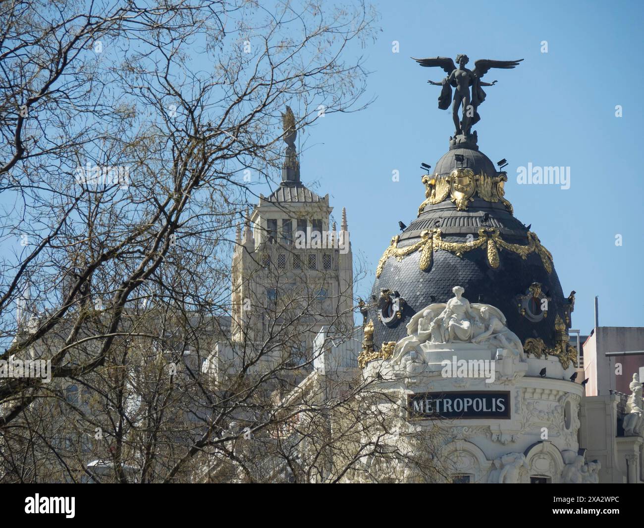 Metropolis building with striking architecture and a statue on the dome ...