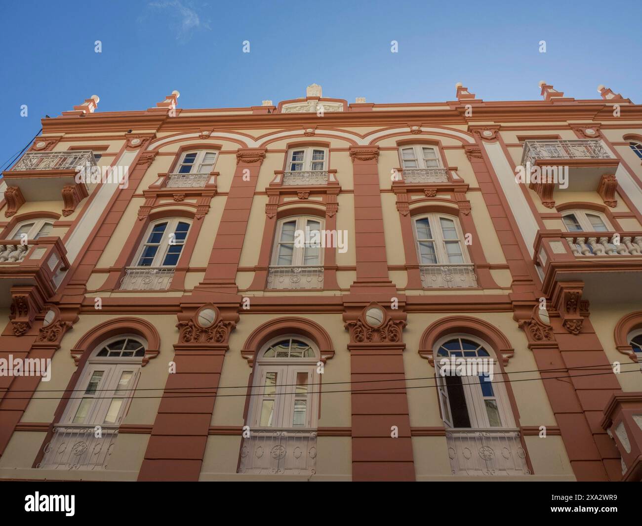 A historic, multi-storey building with ornate pink and white ...