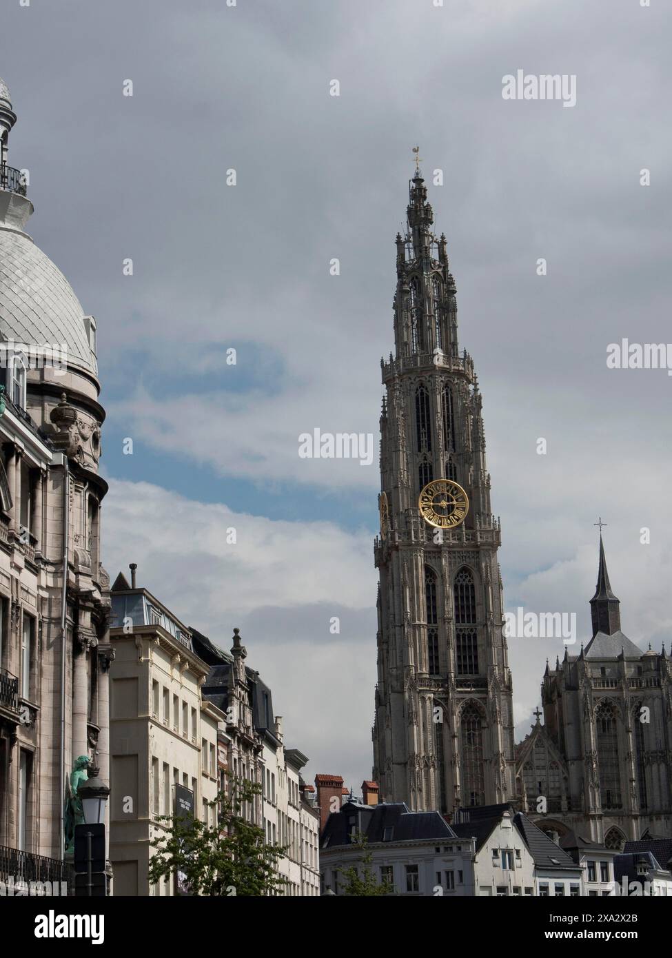 Historic buildings and the steeple of a cathedral under a partly cloudy ...