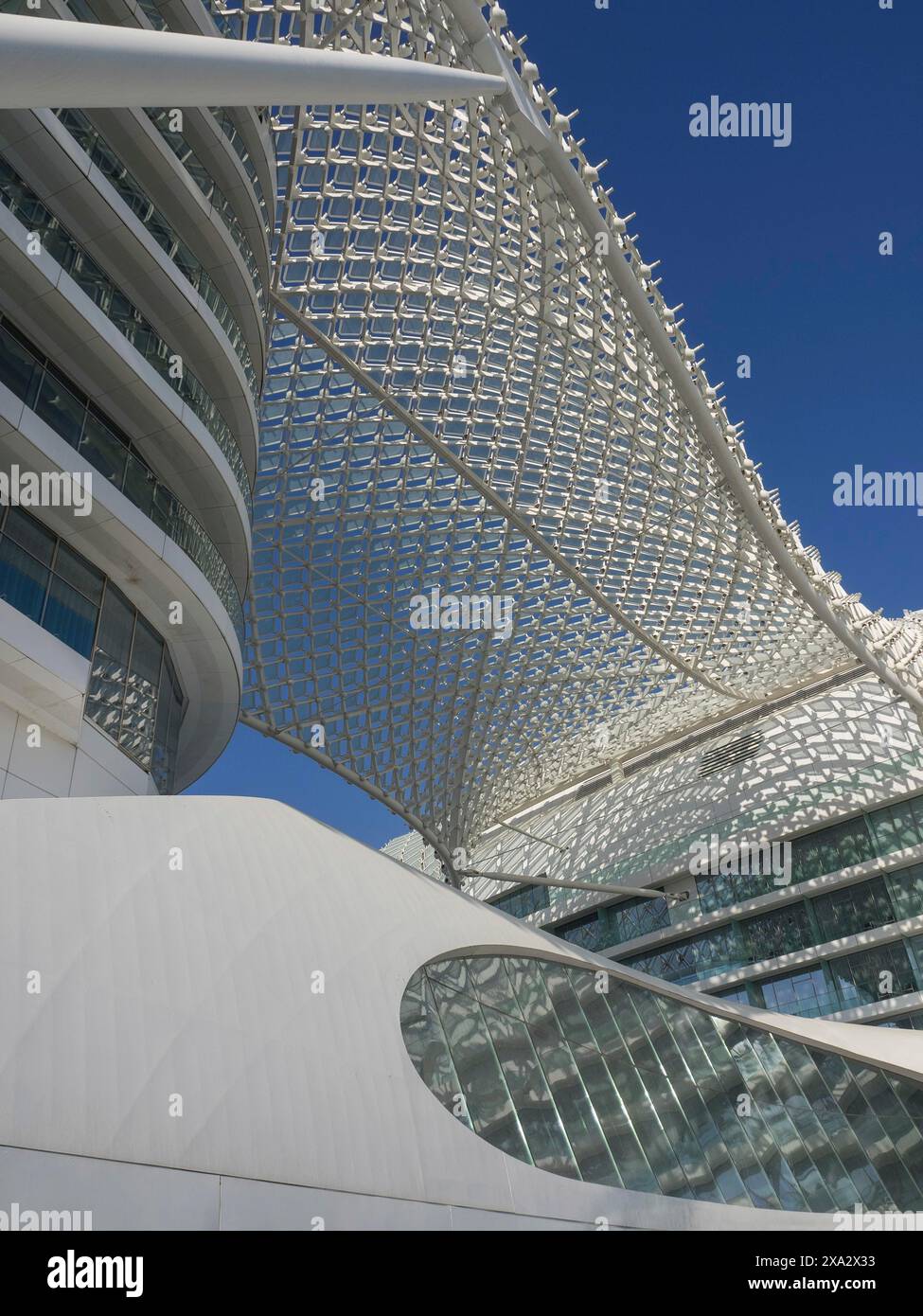Close-up of a modern building with a striking glass structure and a ...