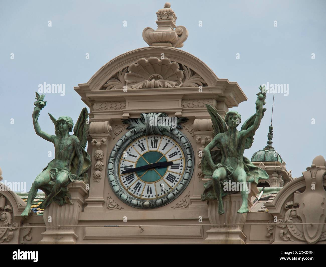 Close-up of an antique roof with a clock and decorative statues, Monte ...