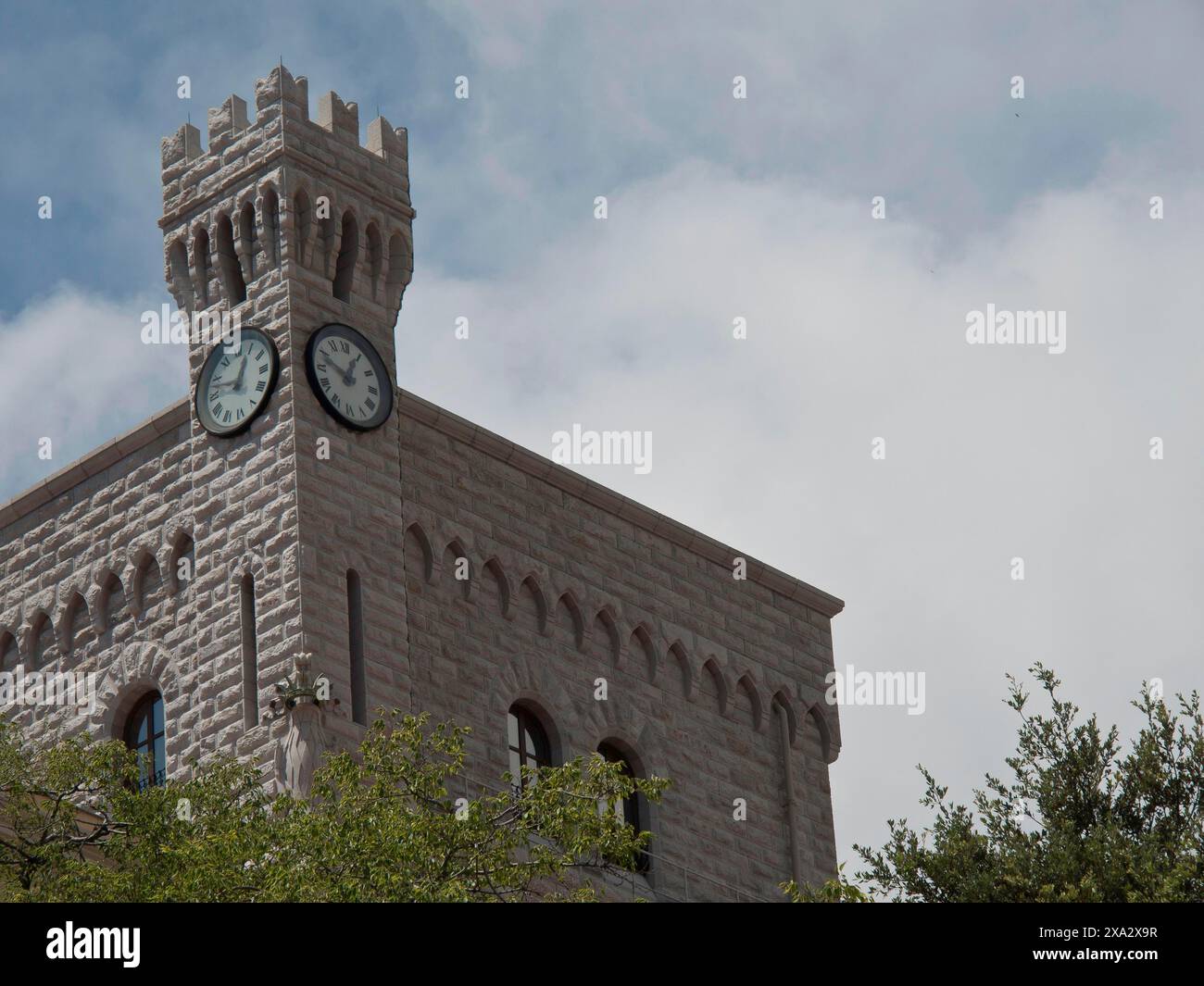 Stone clock tower on a historic building under a cloudy sky, Monte ...