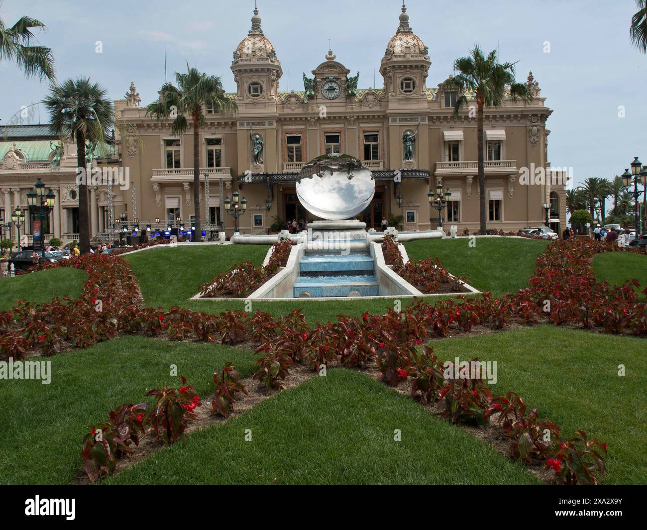 Historic building with palm trees and a decorative fountain in a well ...