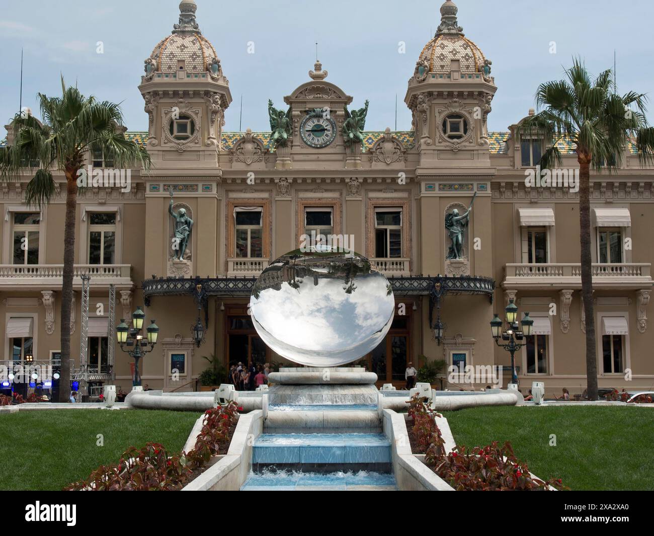 A magnificent palace with a mirror ball, surrounded by flowerbeds and a ...