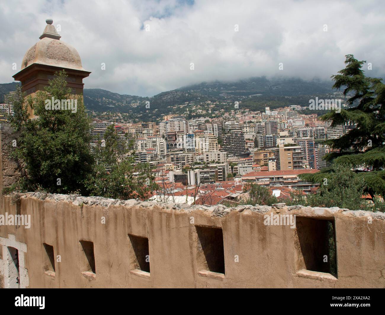 View over a city from an old city wall, surrounded by mountains and ...