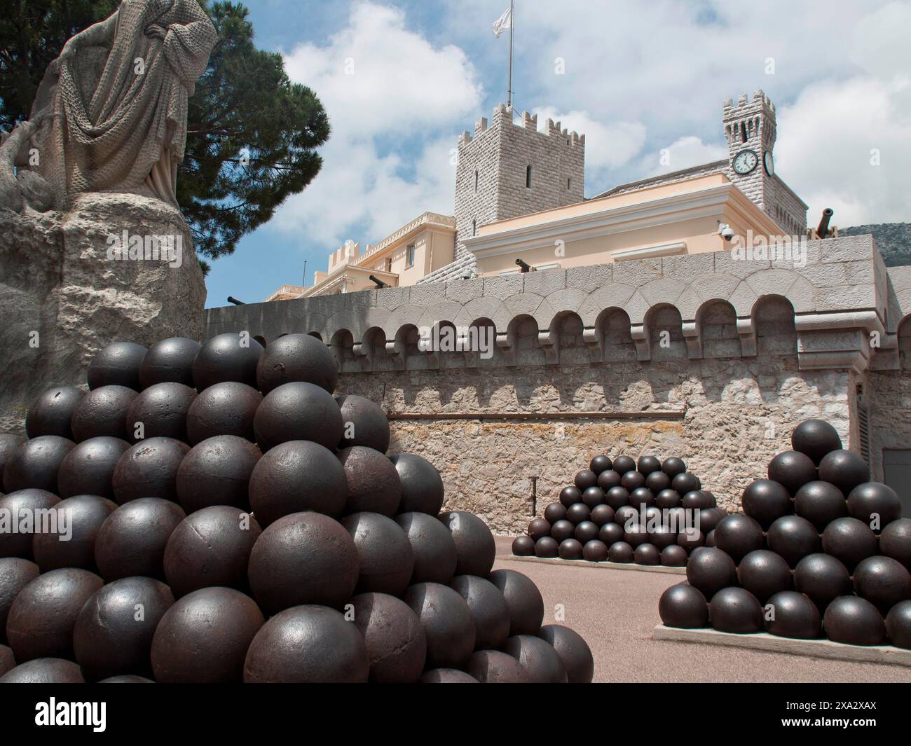 Historic fortress walls with cannonballs and a statue, under a slightly ...