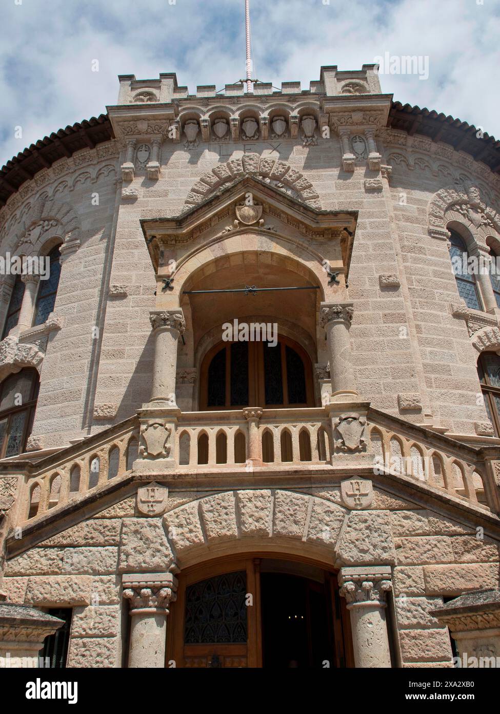 Historic stone building with balcony, ornate windows and entrance ...