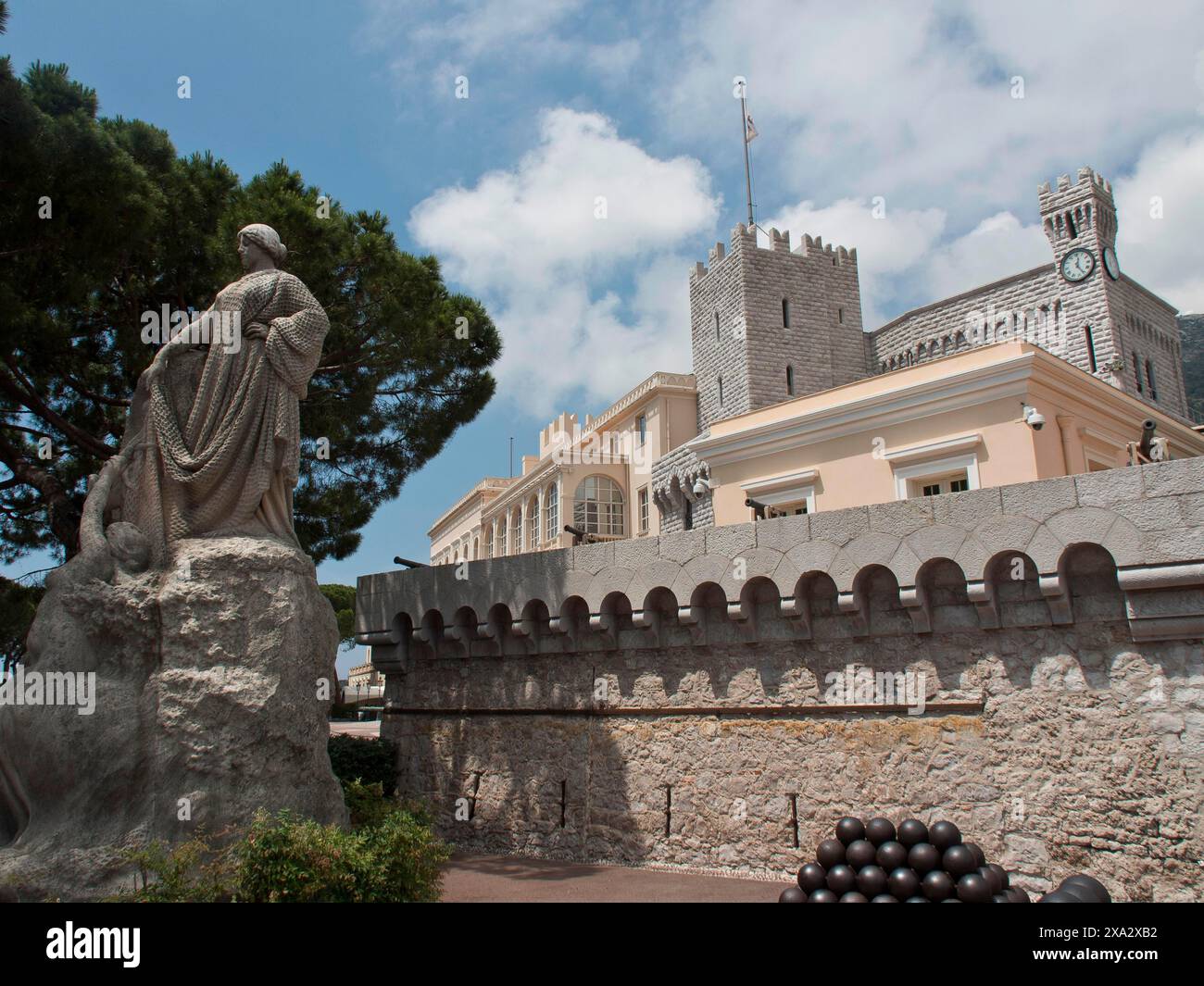Historical scene with statue in front of a high stone wall, next to a ...