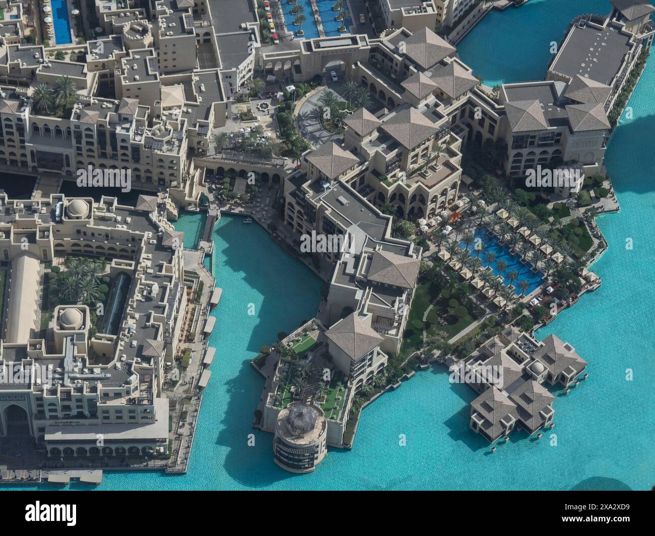 Aerial view of a large building complex with several swimming pools and ...