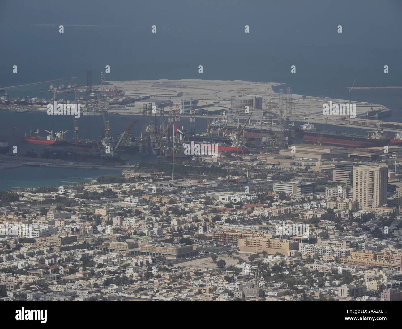 Overview of the harbour of Dubai with several docked ships and the city ...