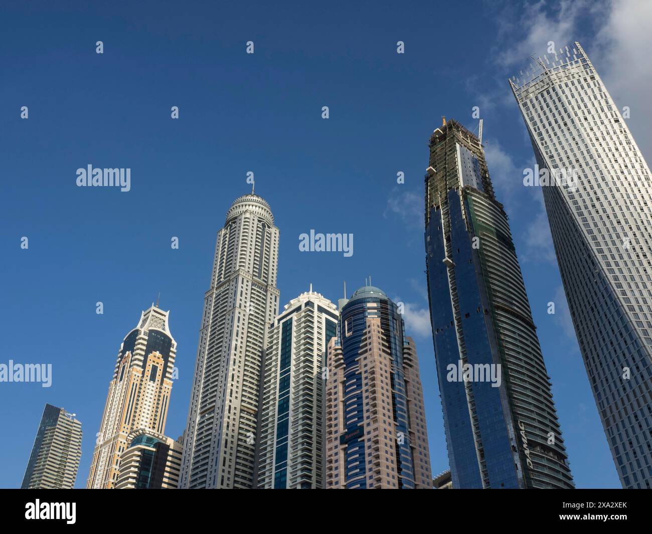 Skyscrapers of various sizes in front of a clear blue sky, Abu Dhabi ...