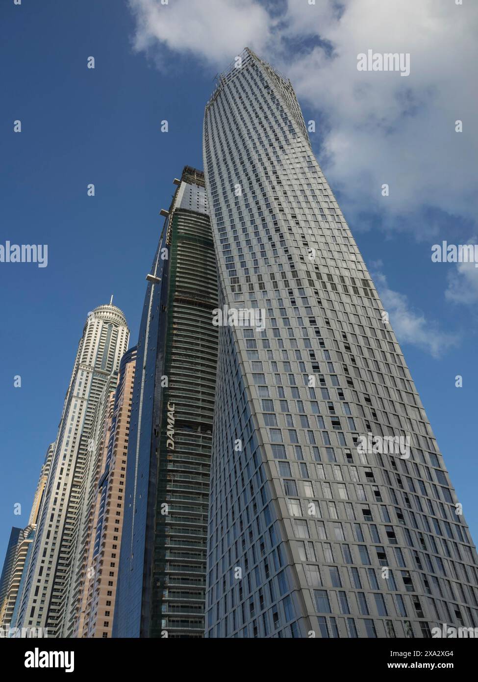 Modern skyscrapers with glass facades in front of a blue sky with some ...