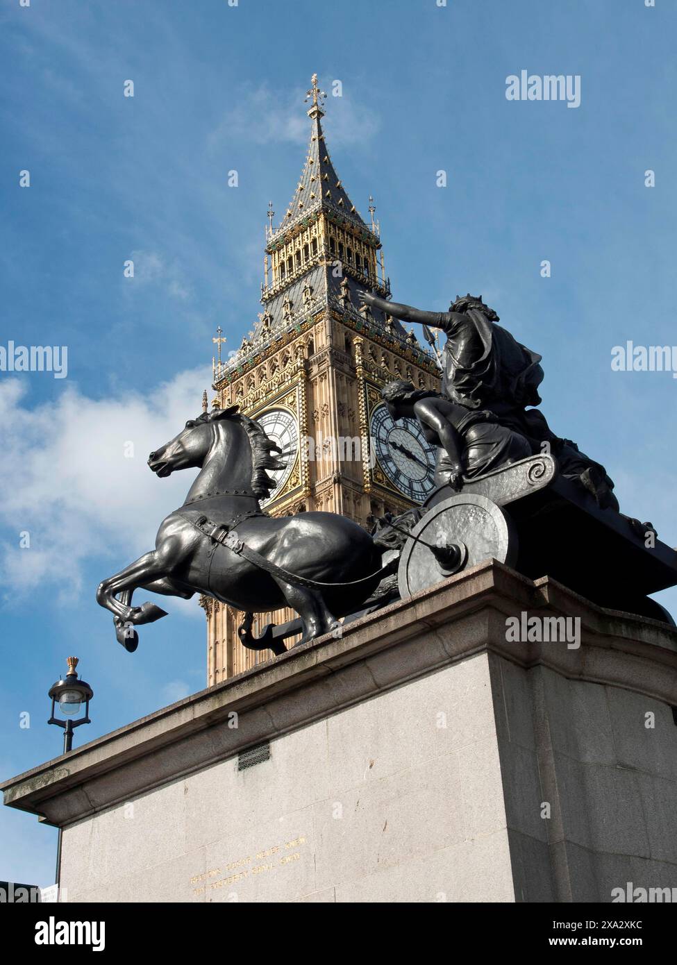 Statue of a chariot with horses in front of Big Ben in London under a ...