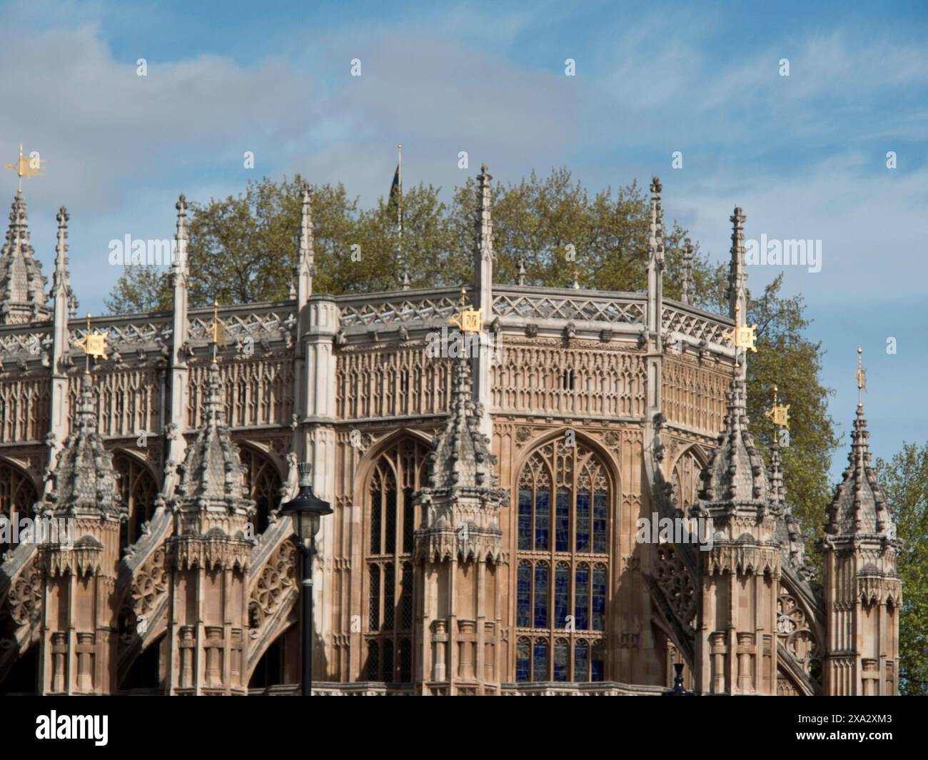 Gothic building with many decorative towers and gilded details, behind ...