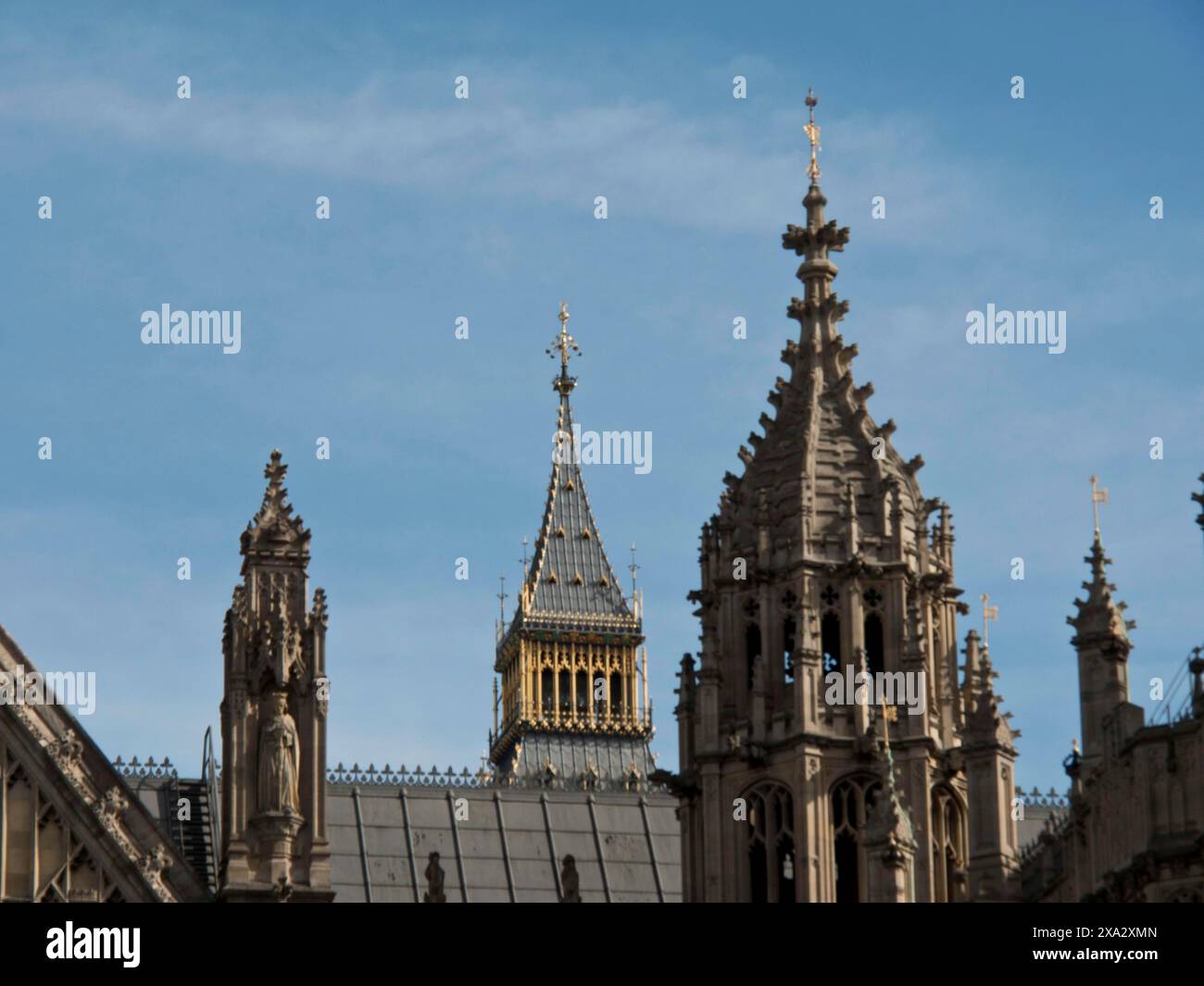 Detail of a gothic building with towers and roof spires, smaller tower ...