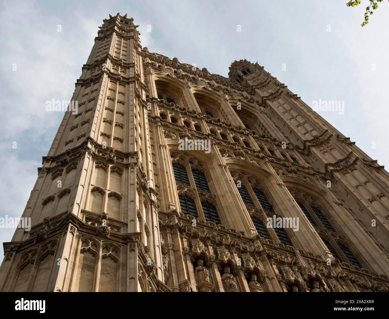 Gothic style tower with decorative stone carvings and windows under a ...