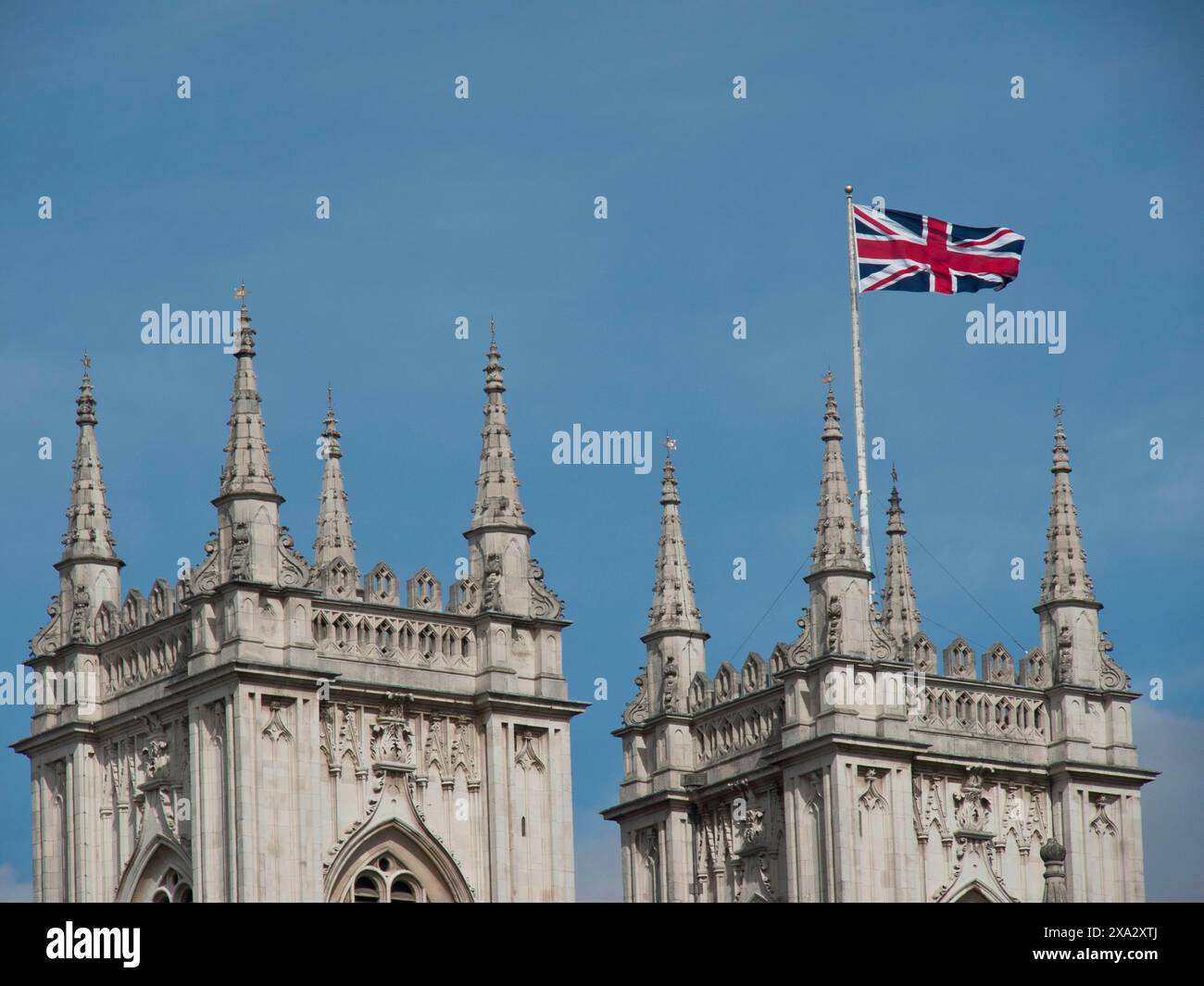 Gothic towers with Union Jack flag in front of blue sky in Great ...