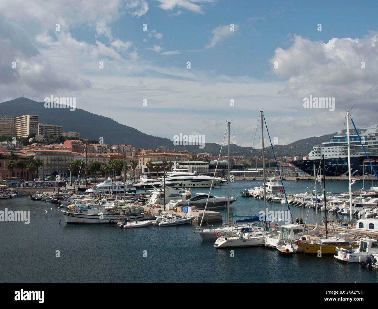 Harbour view with numerous boats and yachts in front of a mountain ...