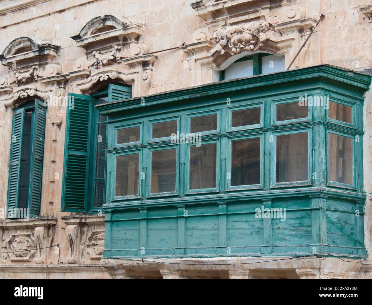 Historic buildings with green shutters and detailed facade architecture ...