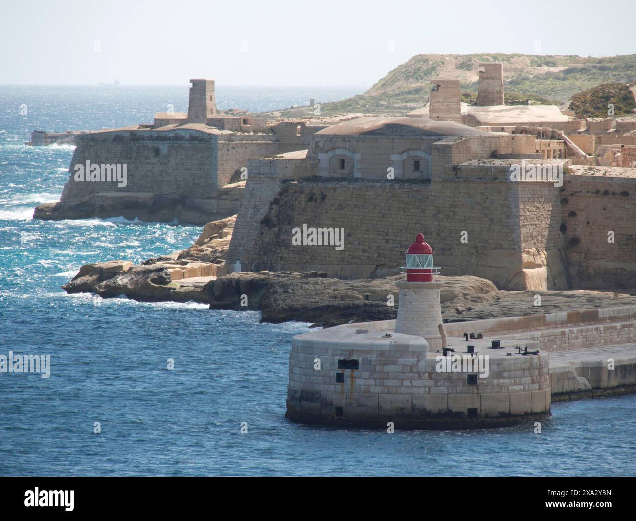 Coastline with historic lighthouse, parts of a fortress and the sea in ...