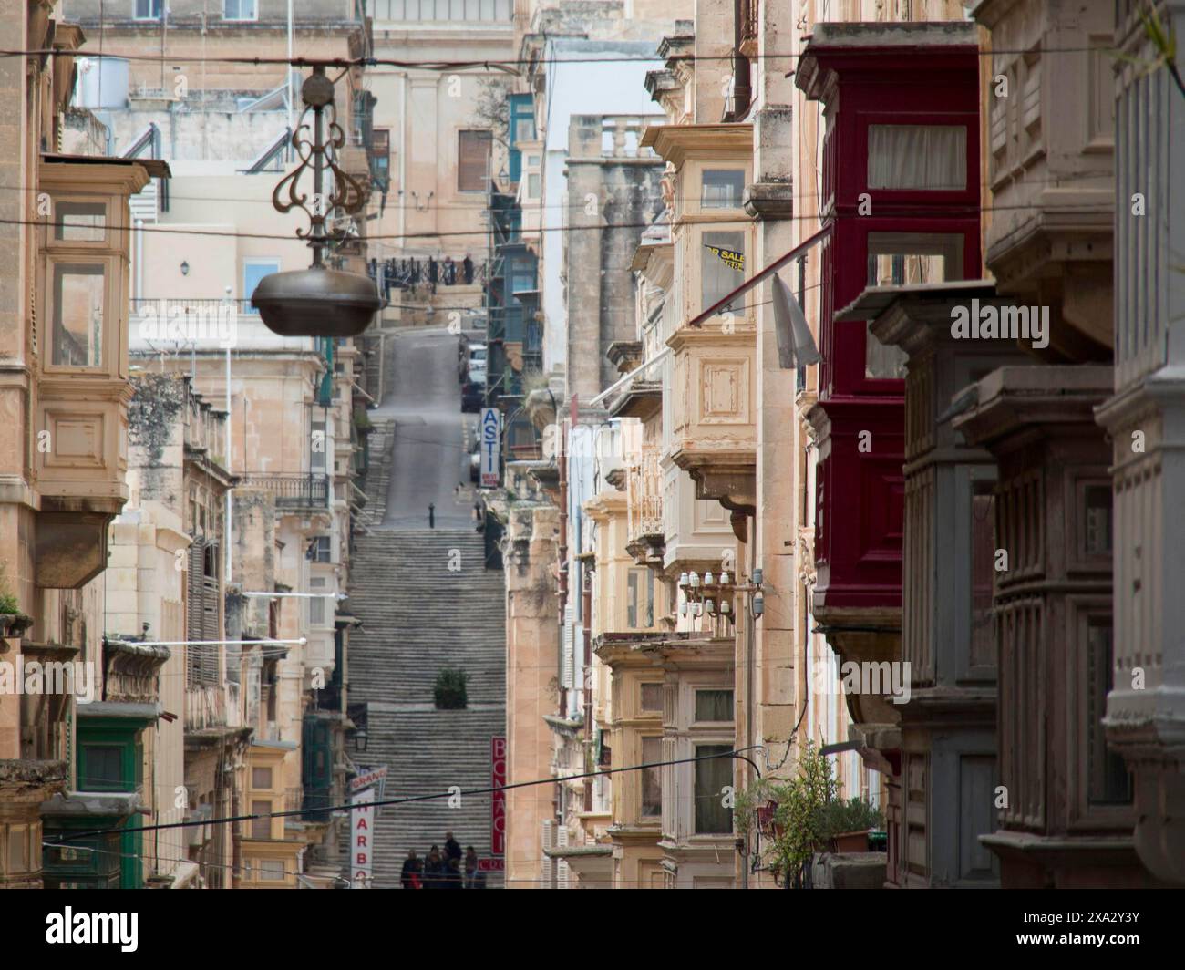 Long, steep staircase leads through narrow alleyways with tall, old ...