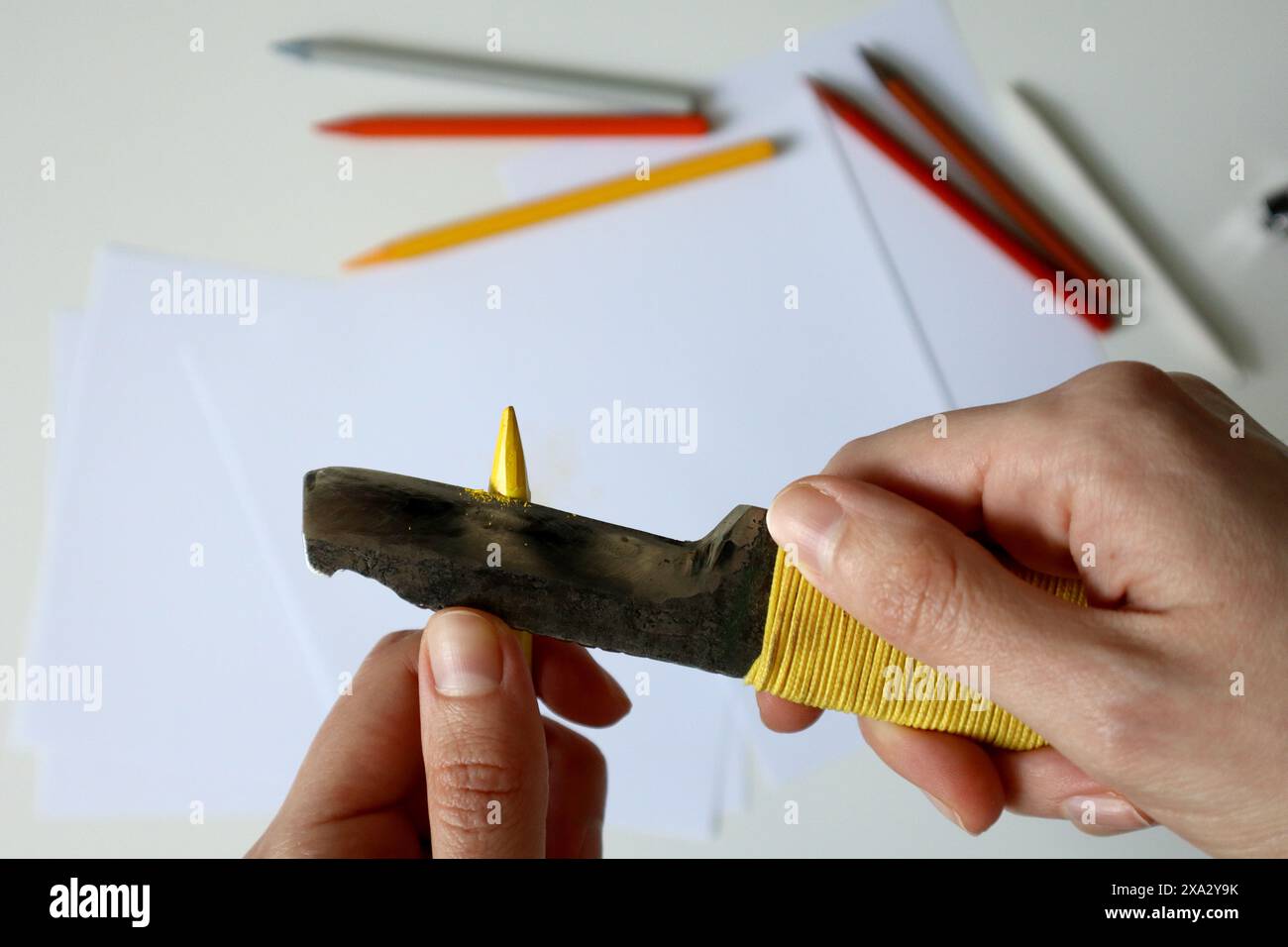 Photo of process of sharpening colored pencils with a clerical knife ...