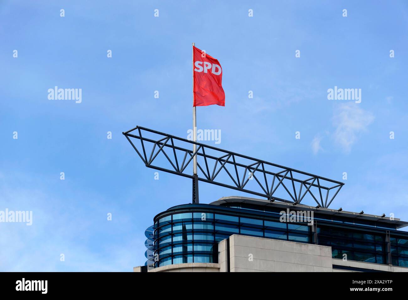 Red SPD flag flies on a modern building under a clear blue sky, Willy ...