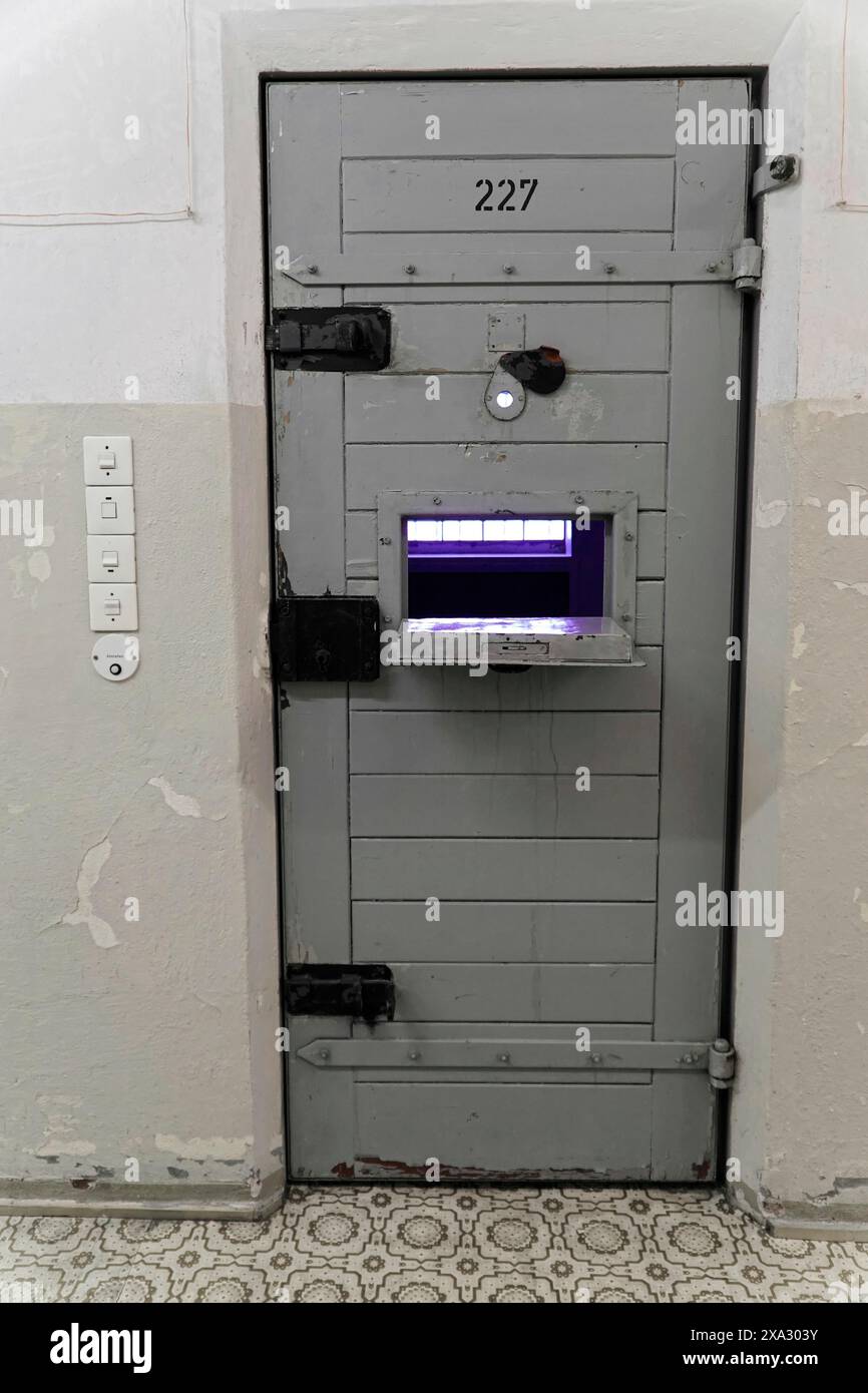 Close-up of a security prison door with food window and worn walls ...
