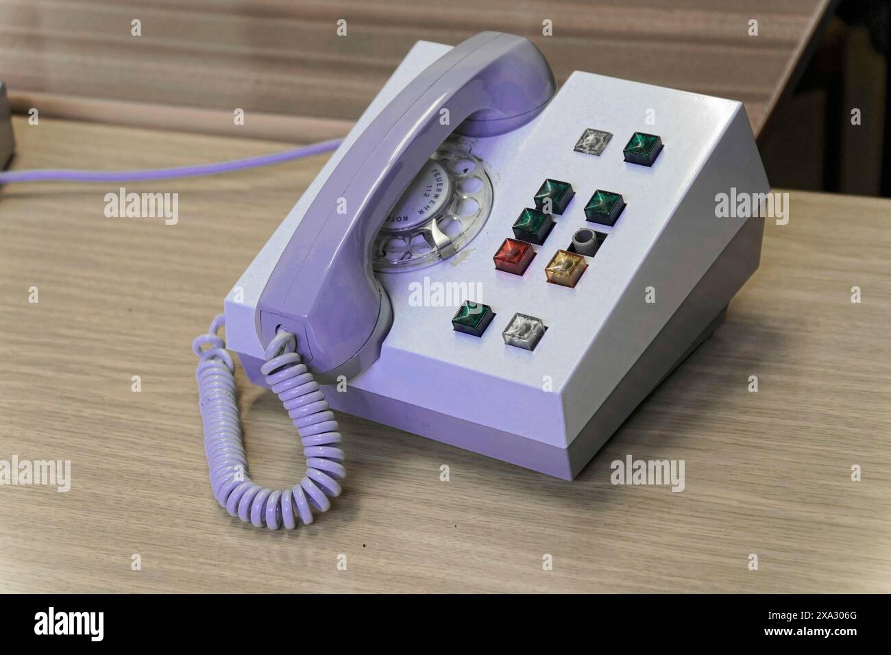 Close-up of an old rotary-disc telephone with various control buttons ...