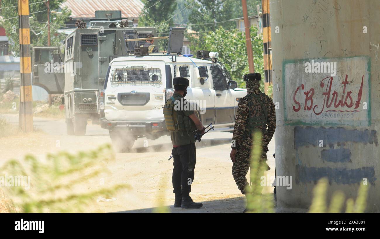 Two soldiers standing near military vehicles in a residential area with ...