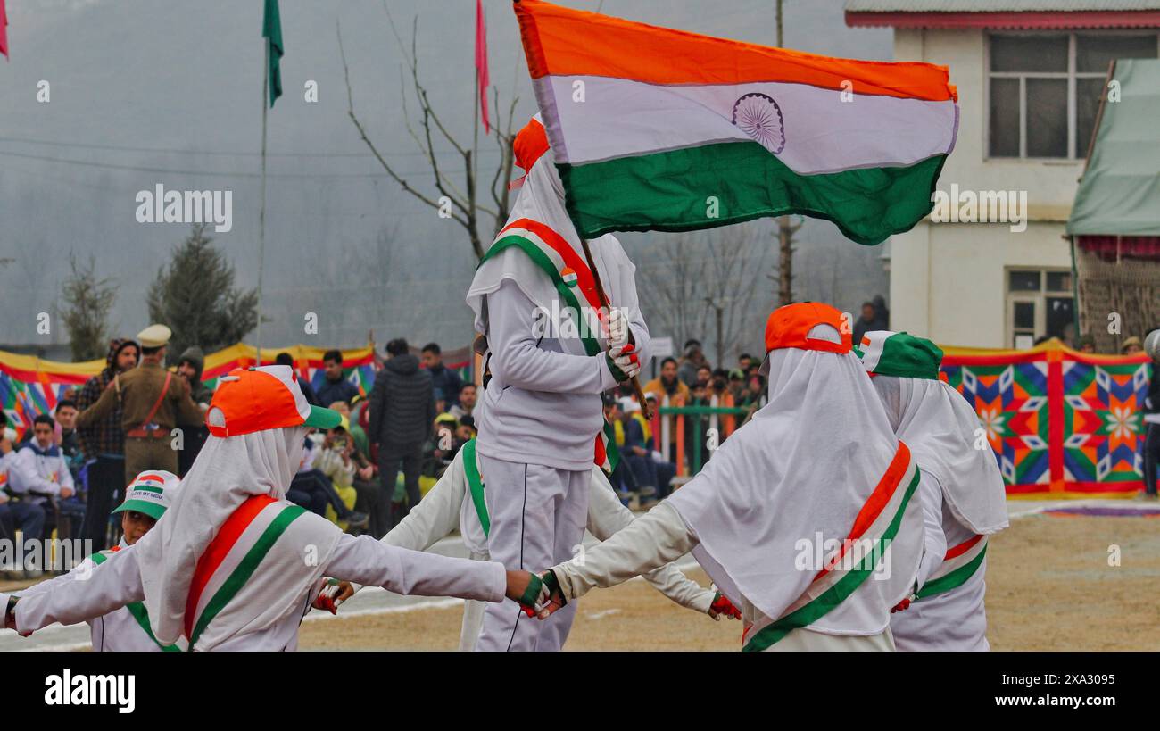 Children in white uniforms holding the Indian flag while participating ...