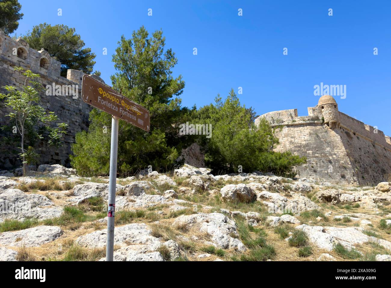 Left foreground sign with reference to historic Fortezza Rethymno right ...