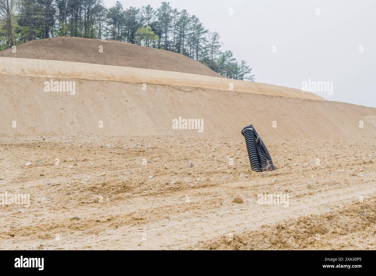 Black corrugated pipes protruding out of ground at rural construction ...