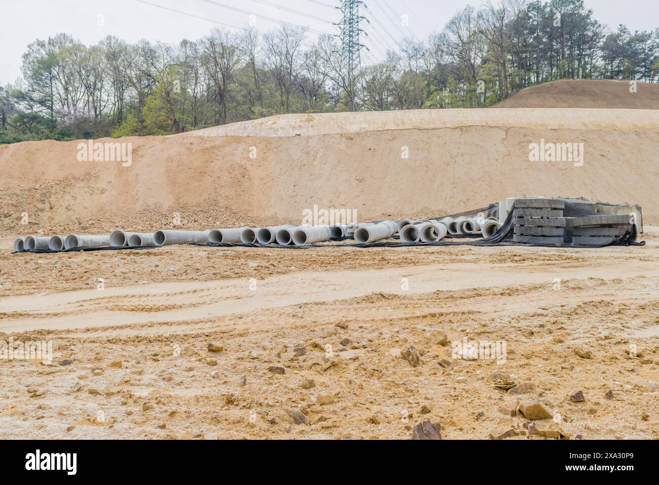 Concrete culvert pipes at base of dirt hillside at rural construction ...