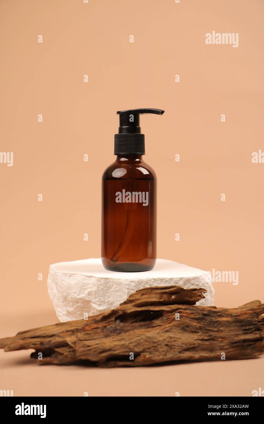 Amber Pump Bottle with Natural Wood on Stone Pedestal Stock Photo - Alamy