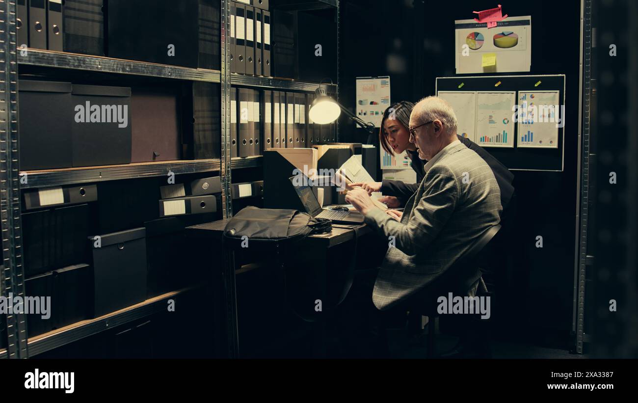 Inspectors team reviewing case information and reading witness ...