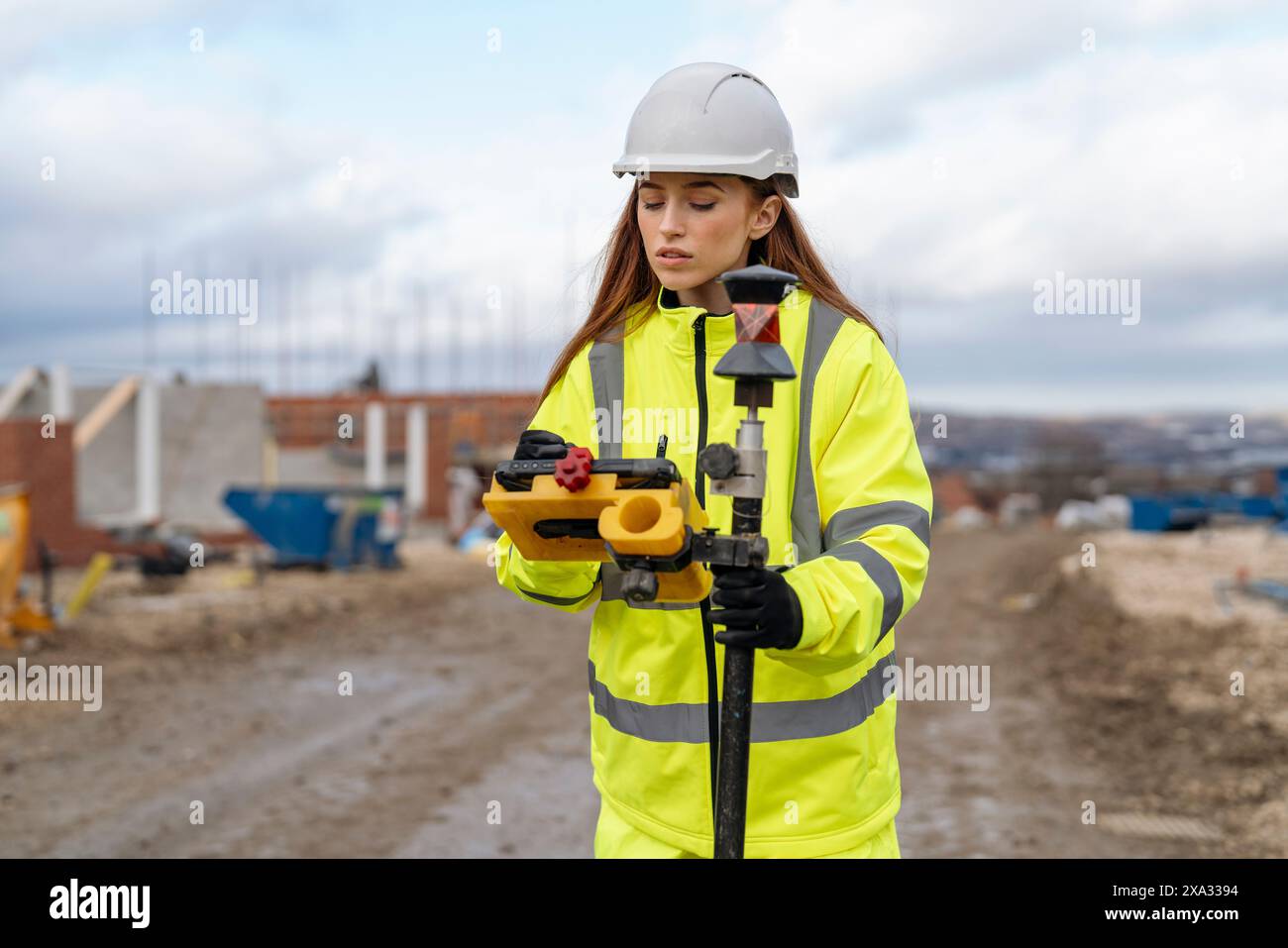 Female site engineer surveyor working with theodolite total station EDM ...