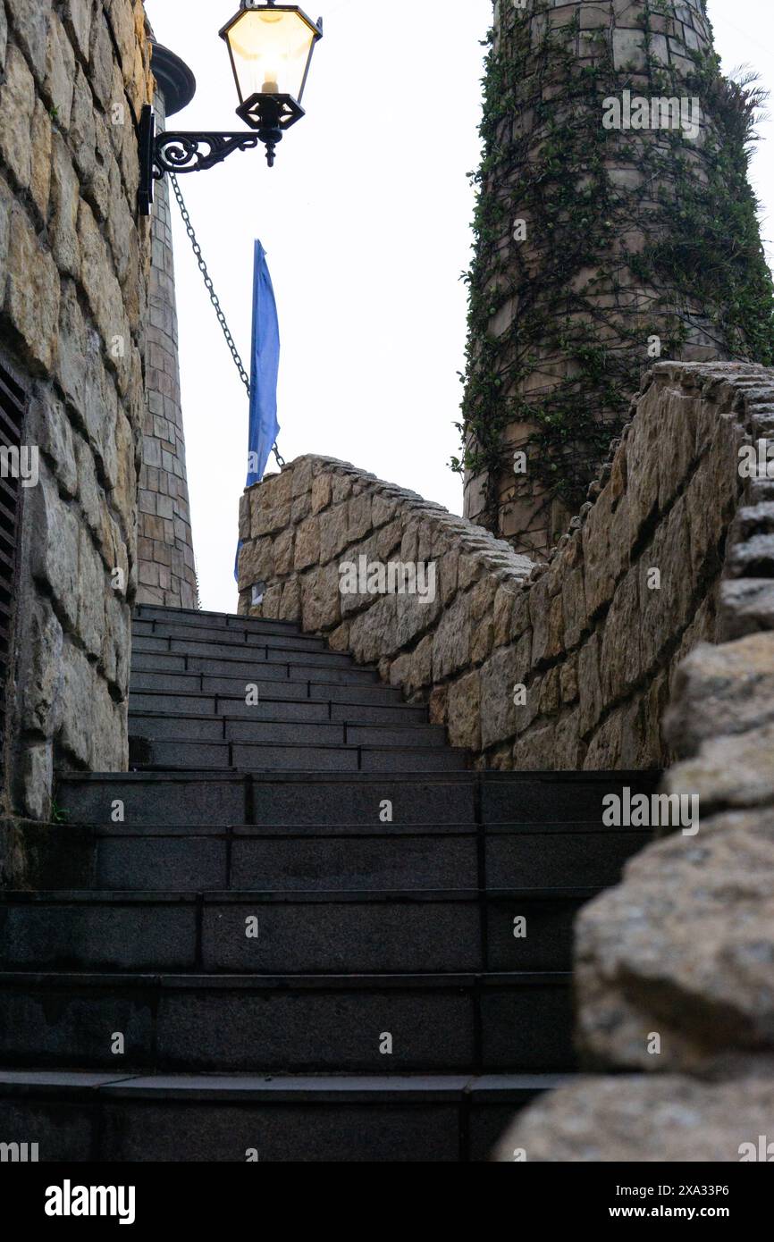 Stone ancient staircase in an old castle leading to the upper floor. A ...