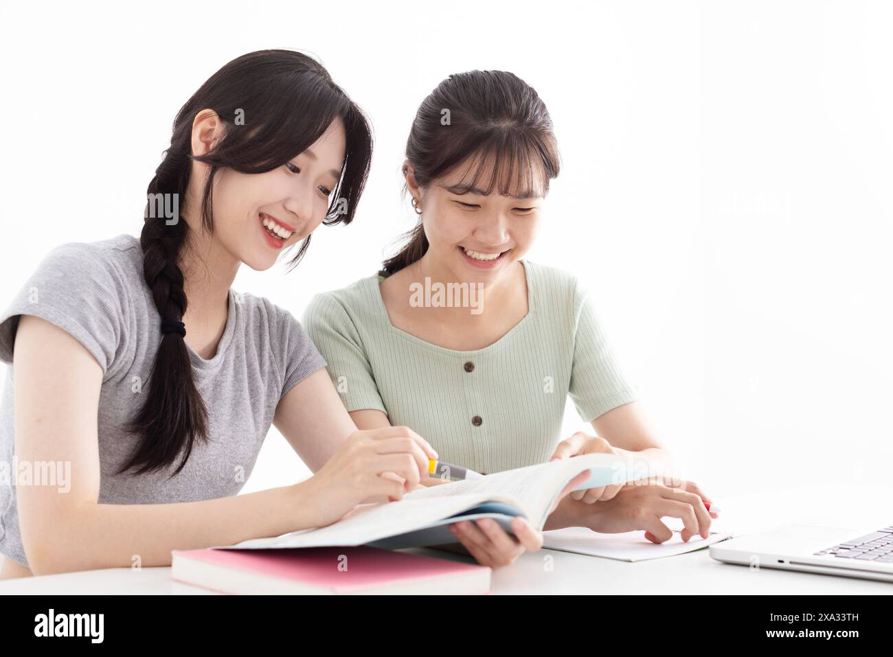 Two students doing homework together and helping each other Stock Photo ...