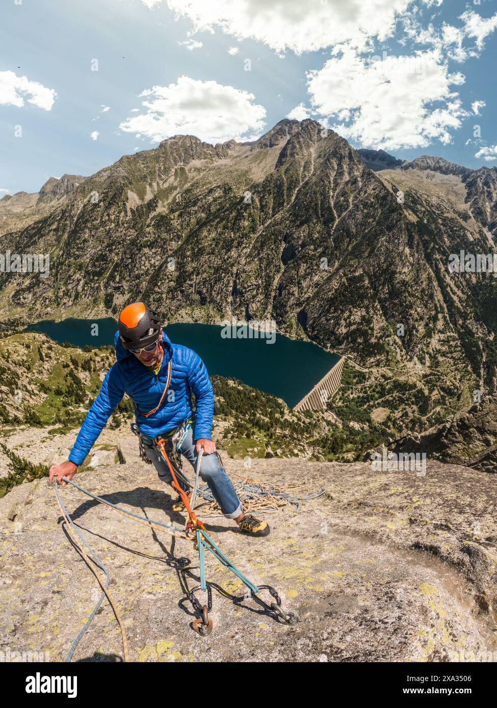 man climbing high mountains in the Pyrenees dramatic sunset sky, valley ...