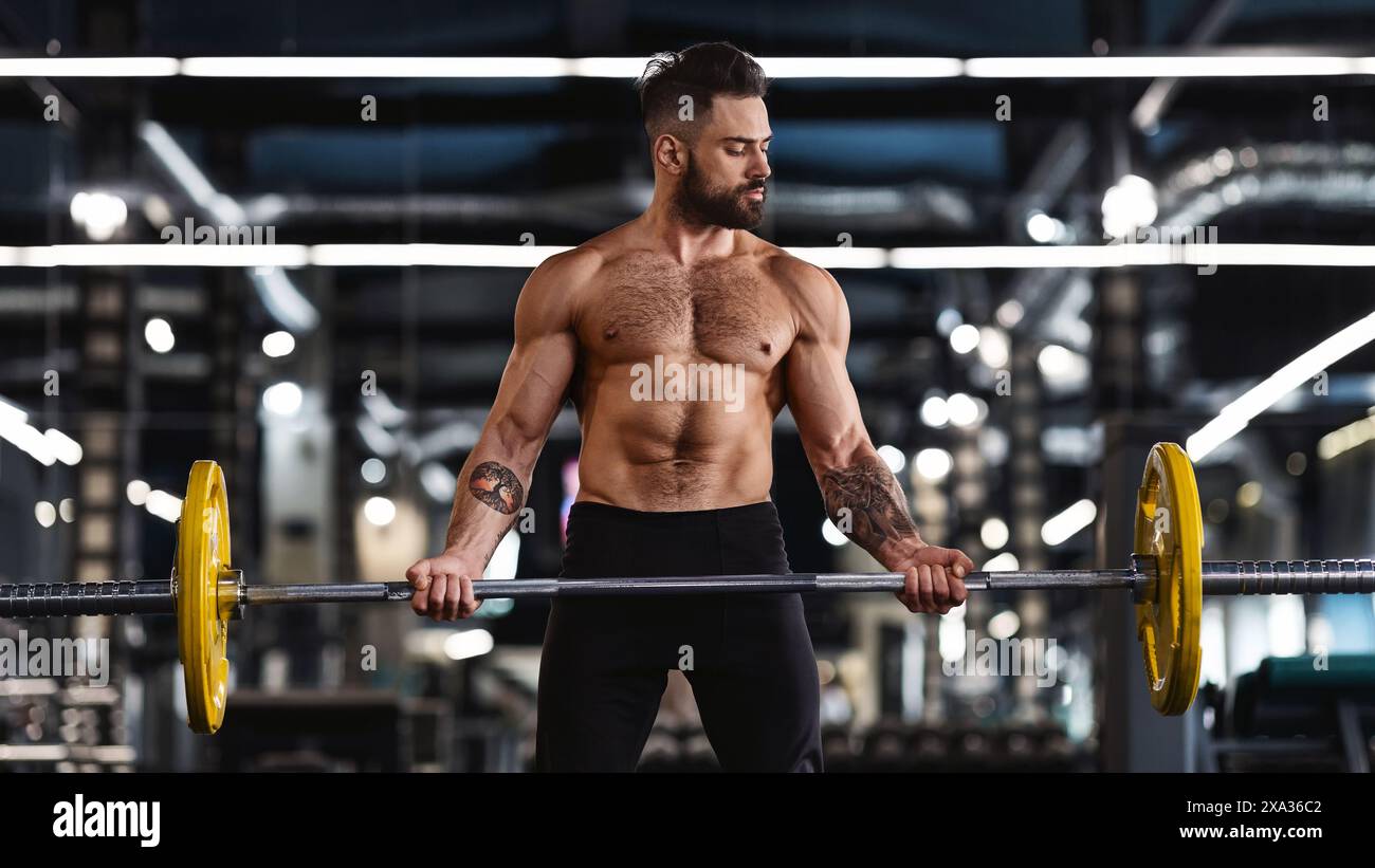 Muscular Man Lifting Weights in a Gym Stock Photo - Alamy